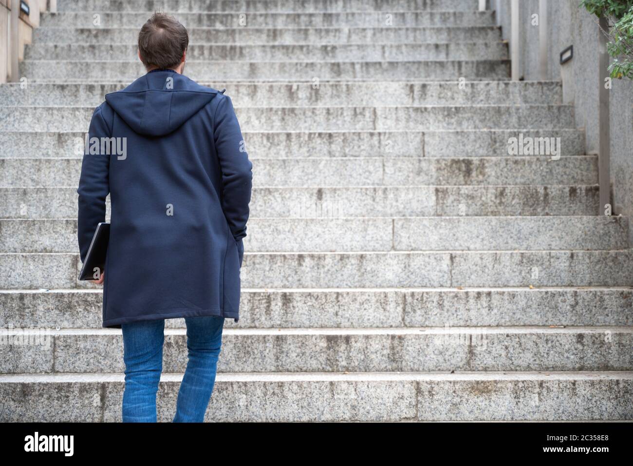 Young man Holding Computer Laptop Walking Up Stairs outdoor Stock Photo ...