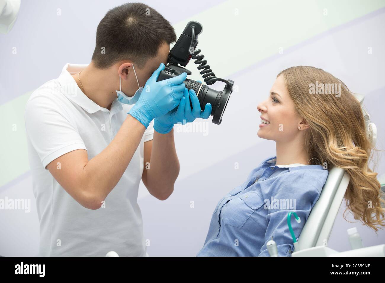 Dentist with camera and patient Stock Photo - Alamy