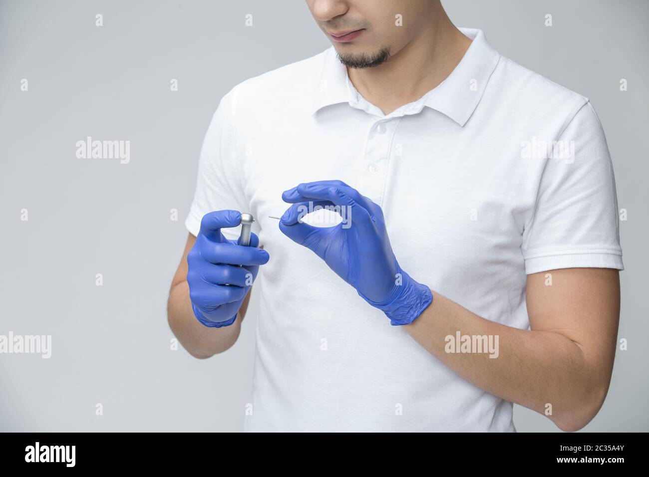 Dentist with dental handpiece Stock Photo - Alamy