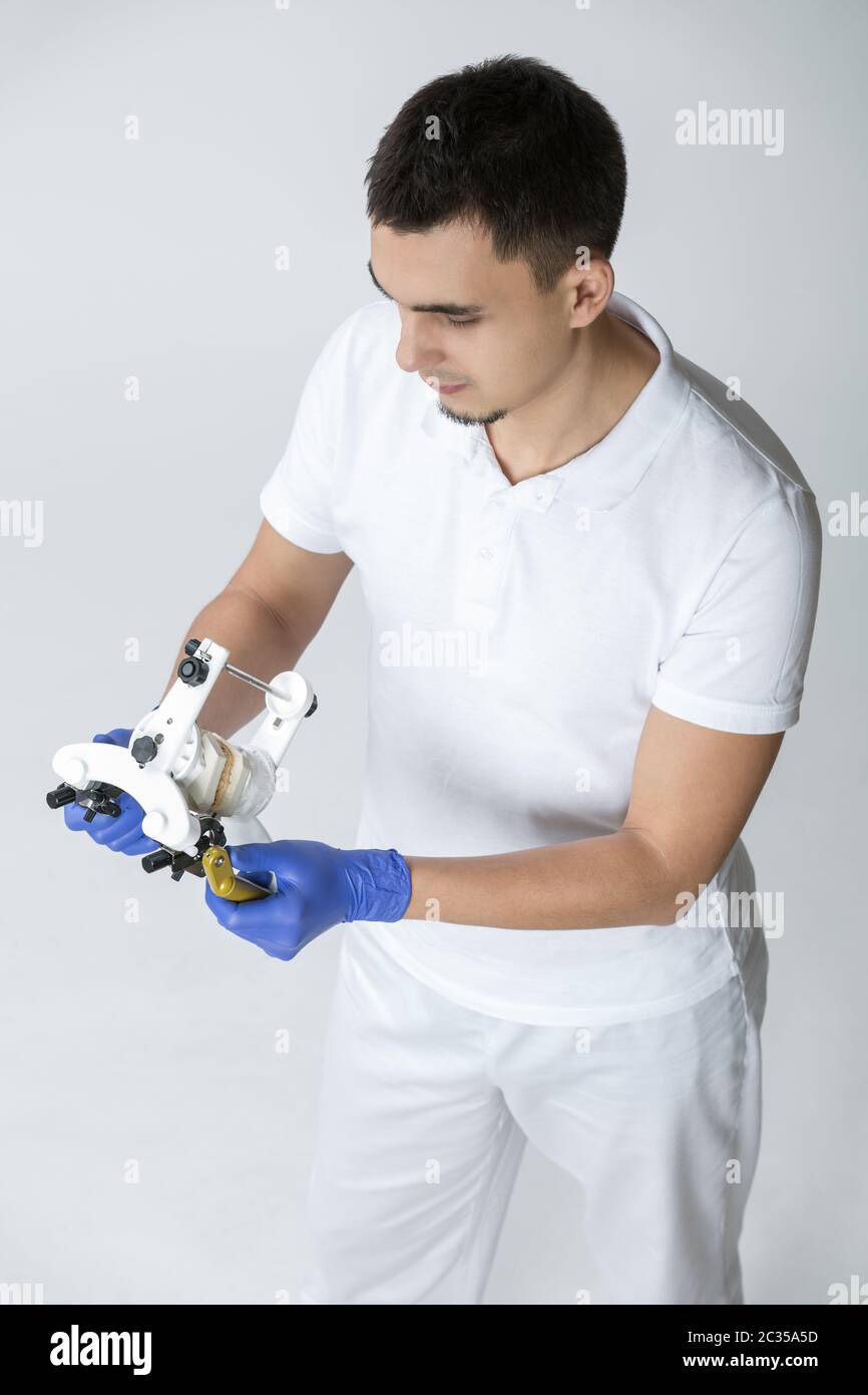 Dentist with parallelometer Stock Photo - Alamy