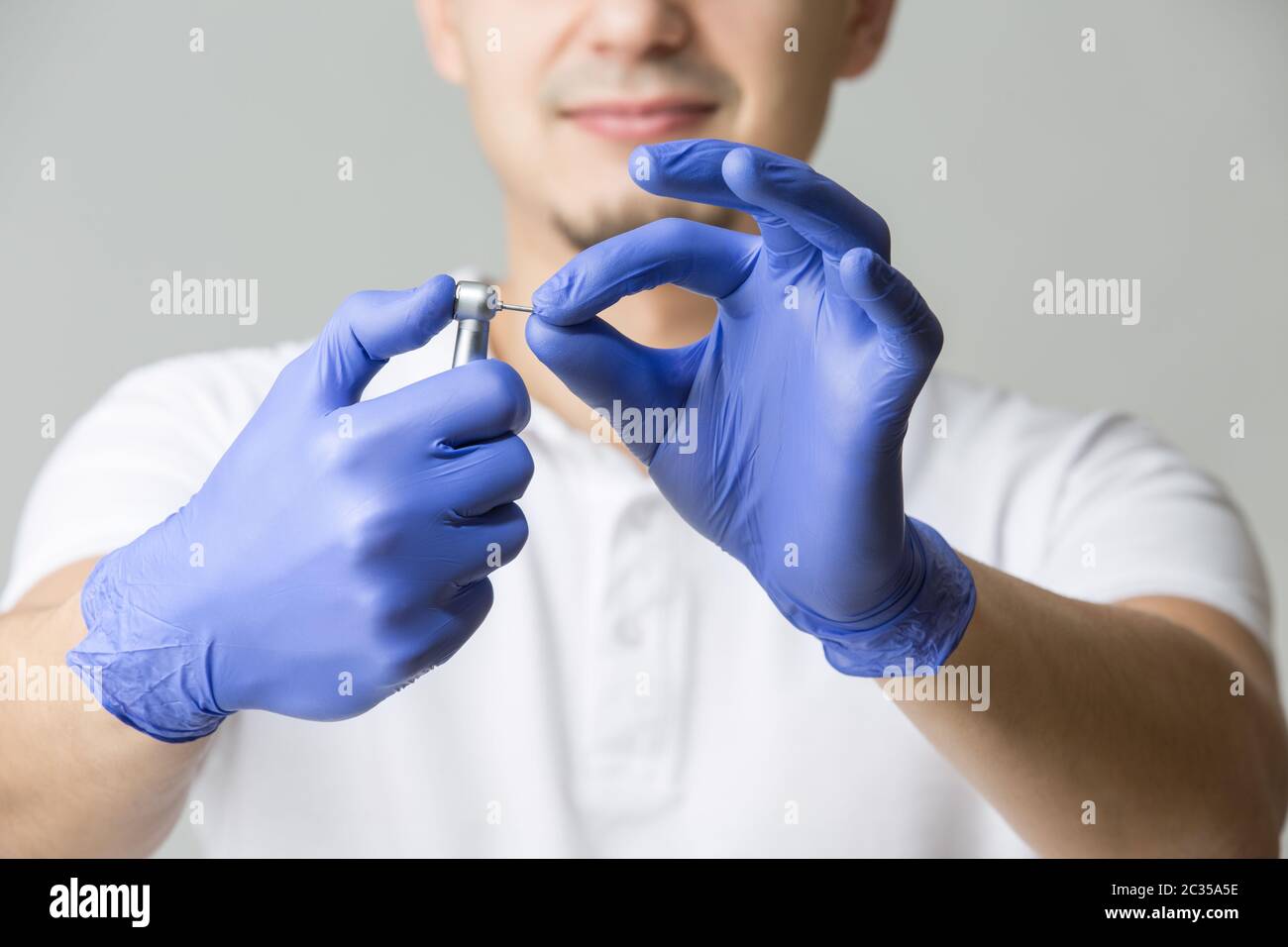Dentist with dental handpiece Stock Photo - Alamy