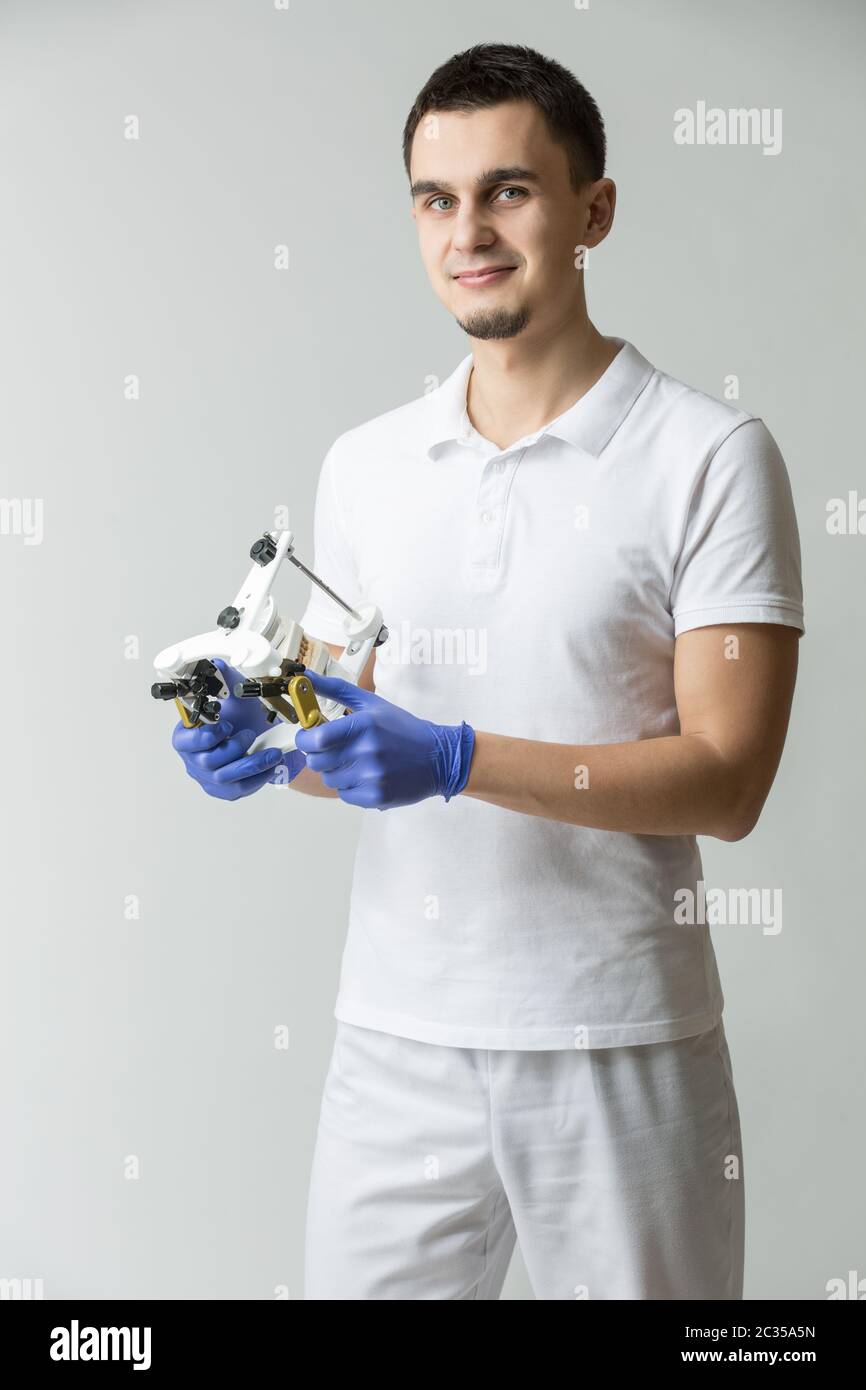 Dentist with parallelometer Stock Photo - Alamy