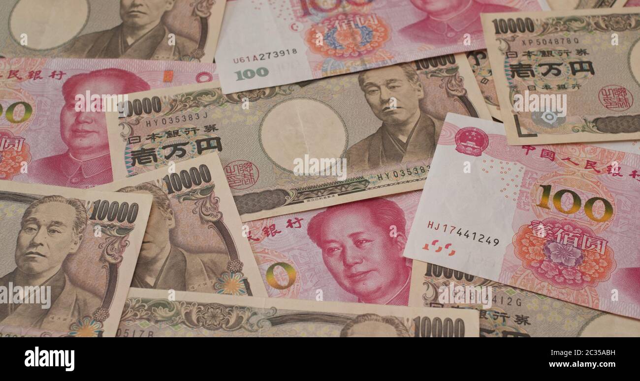 Stack of Chinese banknote and Japanese Yen Stock Photo - Alamy