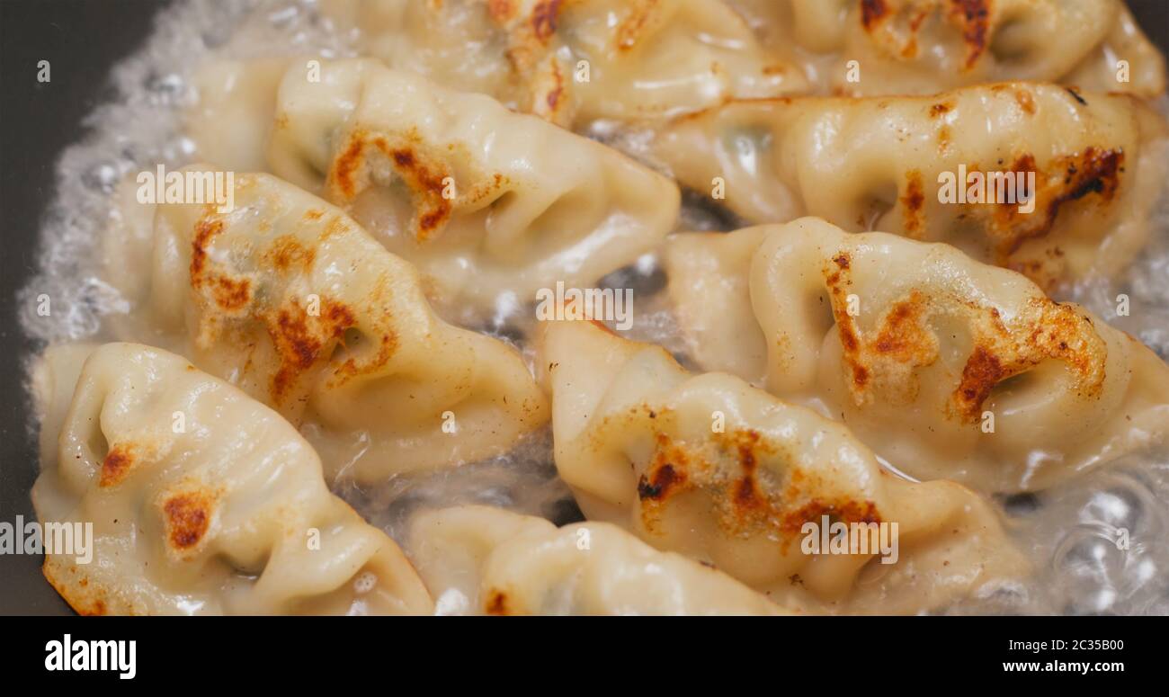 Fry Meat dumpling in pan Stock Photo - Alamy