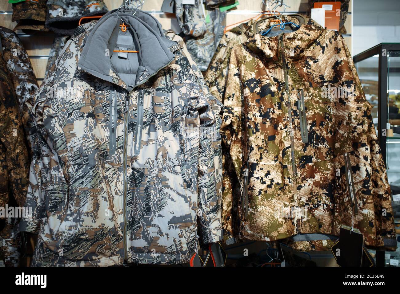 Winter uniform, showcase in gun shop, nobody. Euqipment for hunters on ...