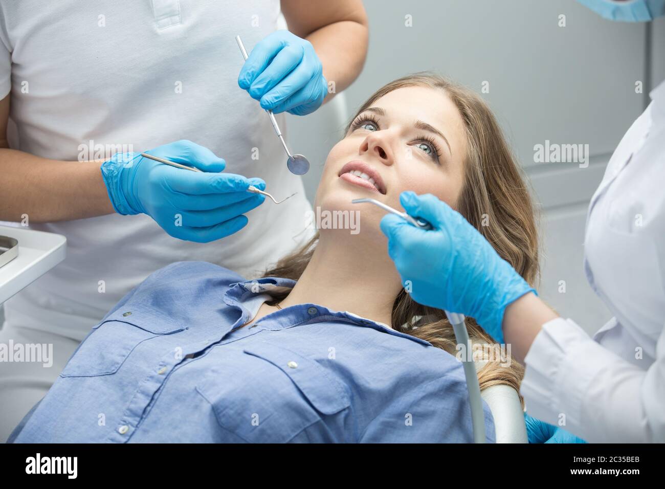 Dentist examining a patient#39;s teeth in the dentist Stock Photo - Alamy