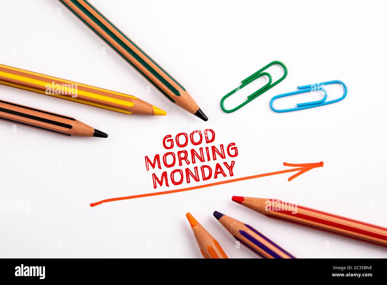 GOOD MORNING MONDAY. Red directional arrow and colored pencils on a ...
