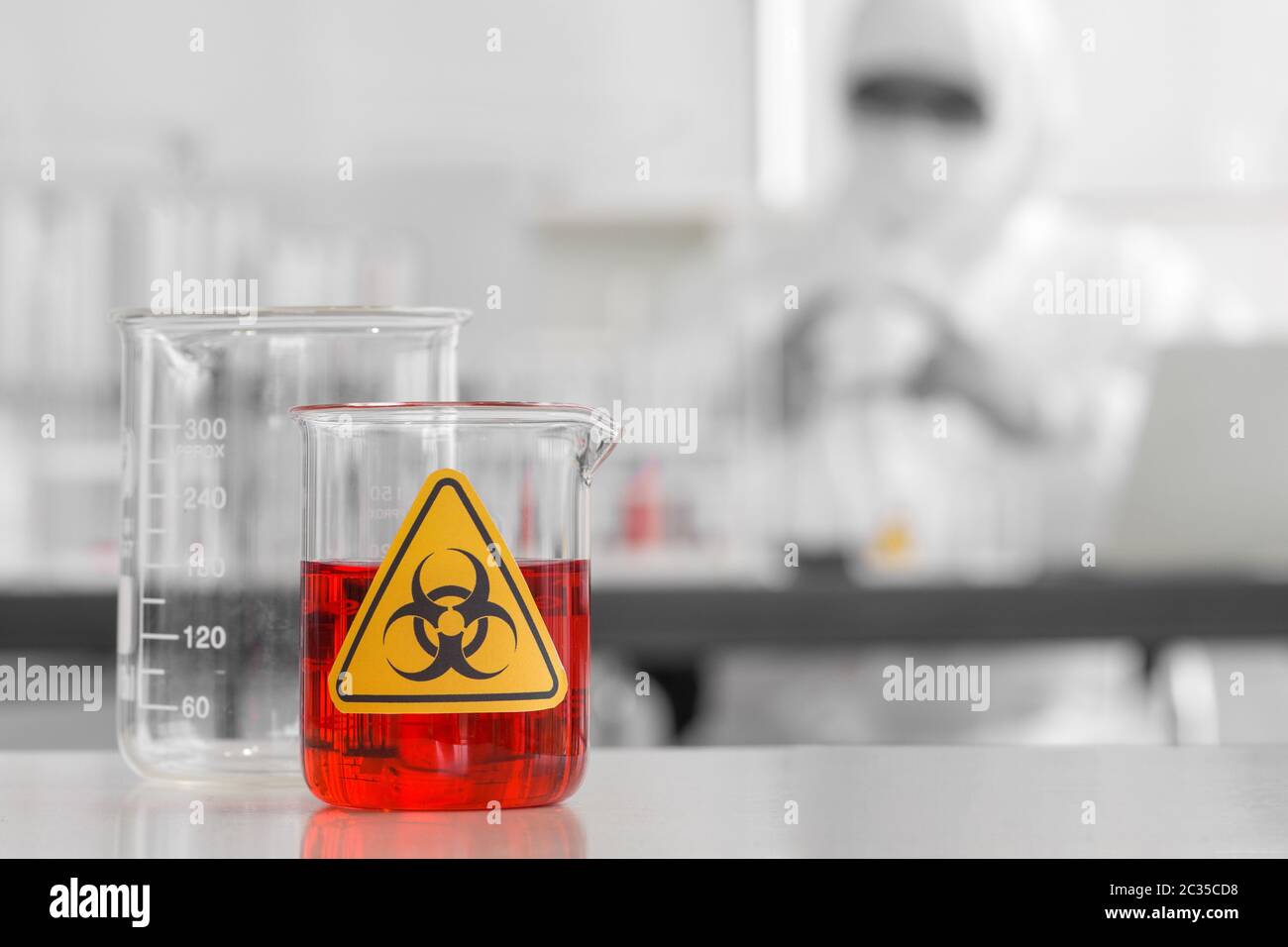 Beaker contains red liquid chemicals on a white laboratory table Stock ...