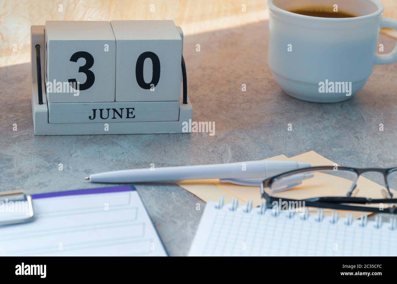 June 30, date on the calendar. Handmade wood cube with date month and ...