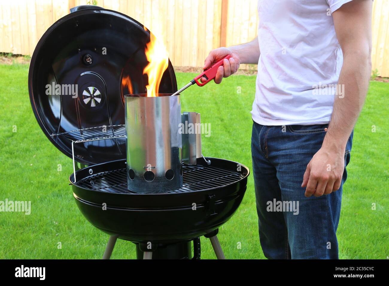 Man roasting beef on BBQ grill Stock Photo - Alamy