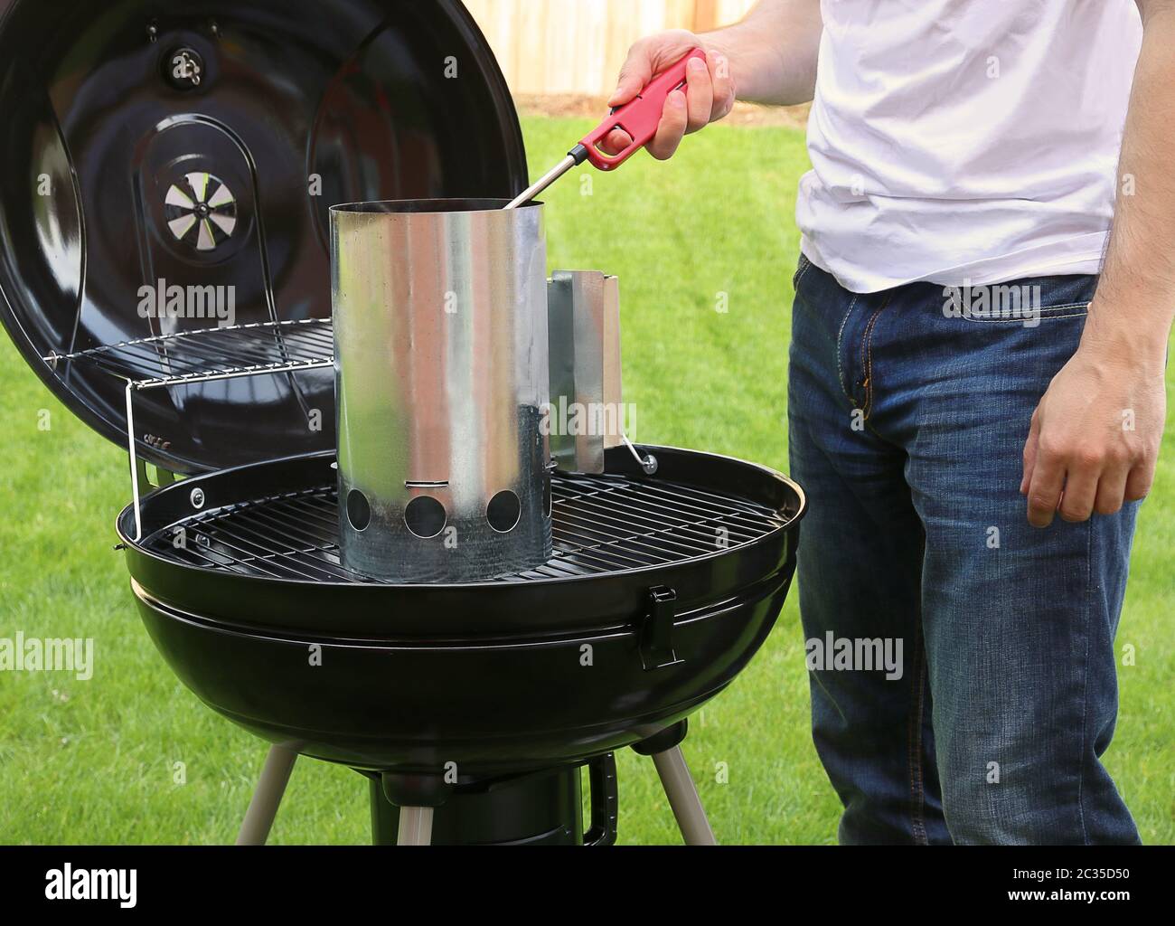 Man roasting beef on BBQ grill Stock Photo - Alamy