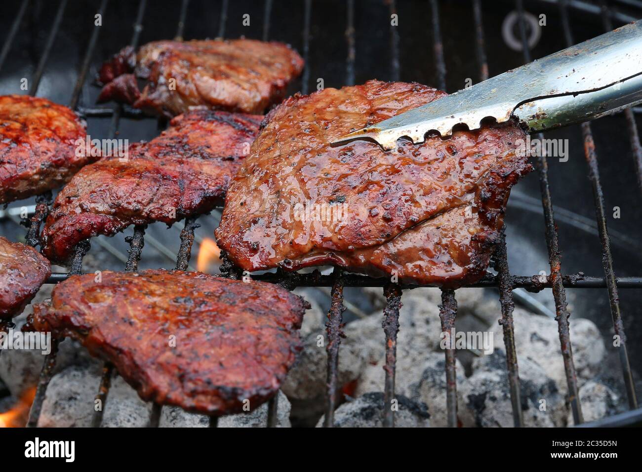 Grilled beef steaks on the grill, close-up Stock Photo - Alamy
