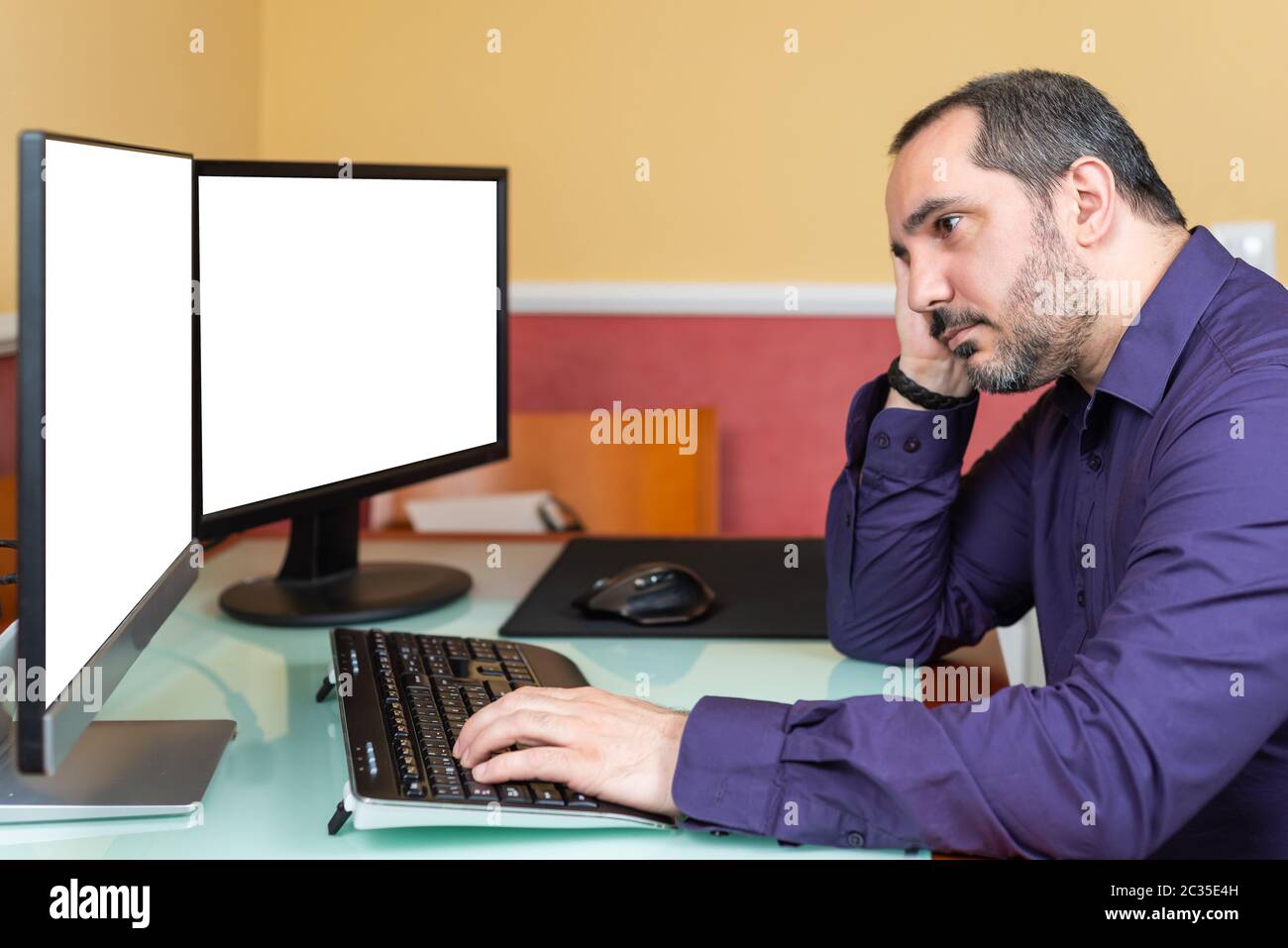 bored man using computer. Telework concept Stock Photo - Alamy
