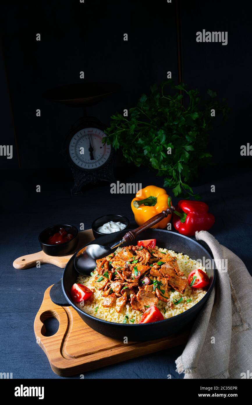 rustic bulgur pans with gratinated gyros and yoghurt Stock Photo - Alamy