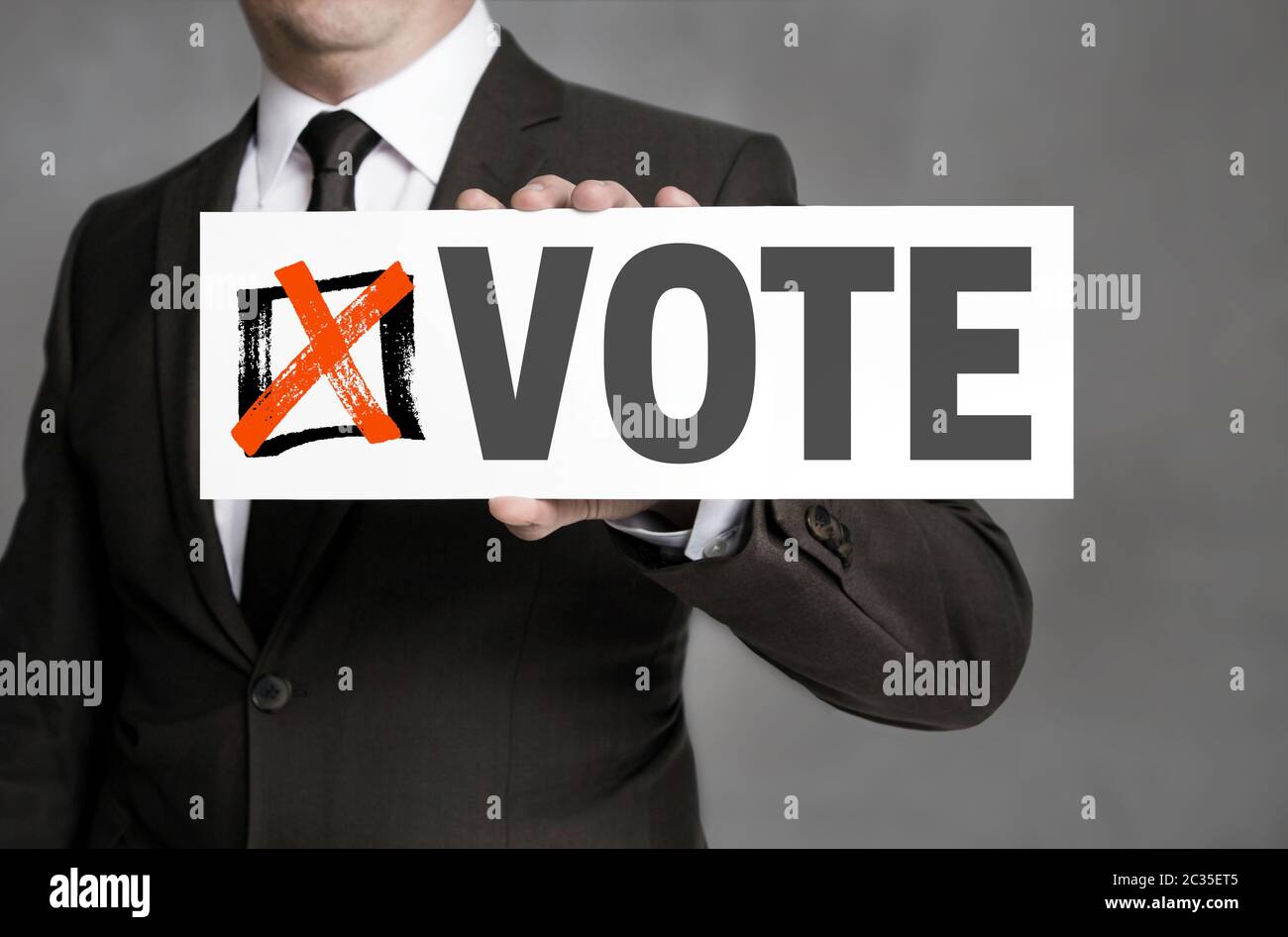 Vote sign is held by businessman Stock Photo - Alamy