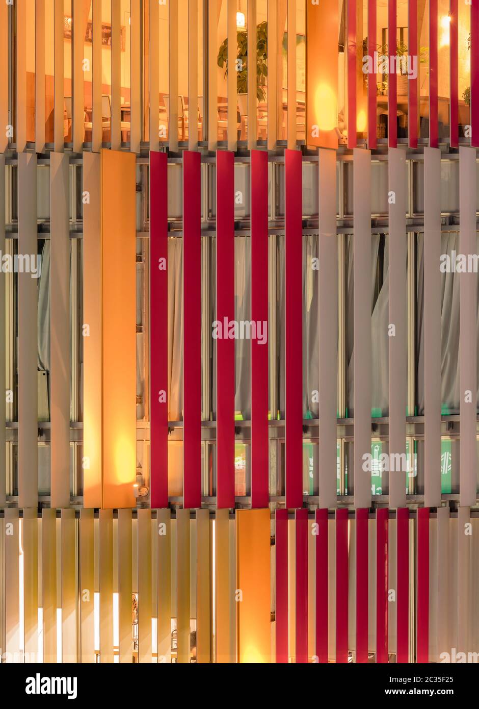 Abstract design front view of a building facade windows with colored ...