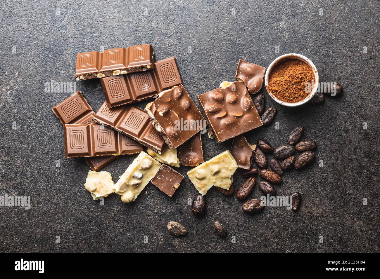 Milk chocolate bars. Dark and white nut chocolate with cocoa powder and ...