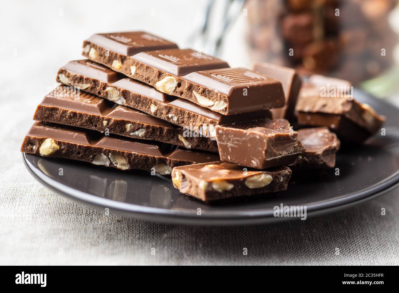 Milk chocolate bars. Dark nut chocolate on plate Stock Photo - Alamy