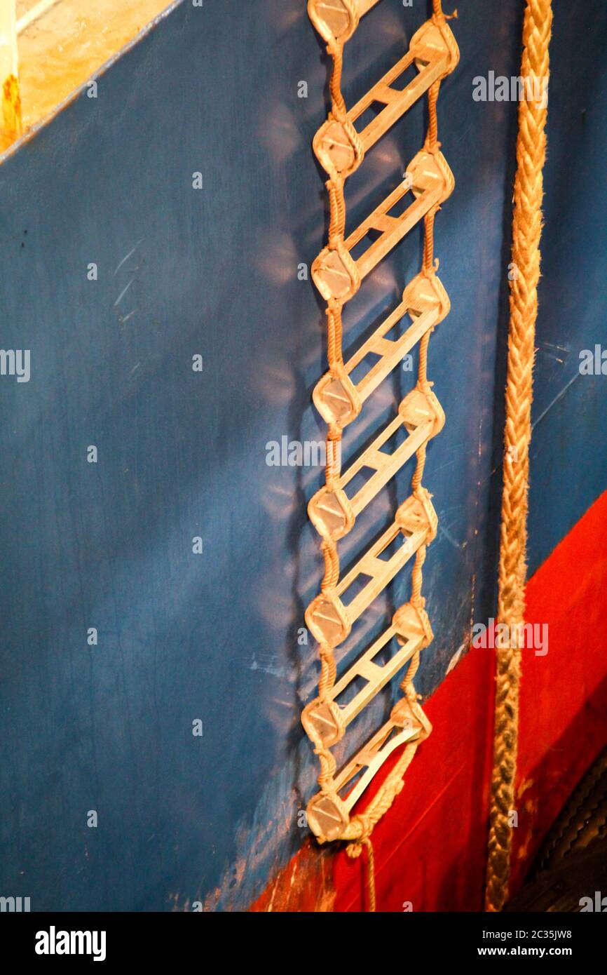a rope ladder hangs down on an outer wall of a ship Stock Photo - Alamy
