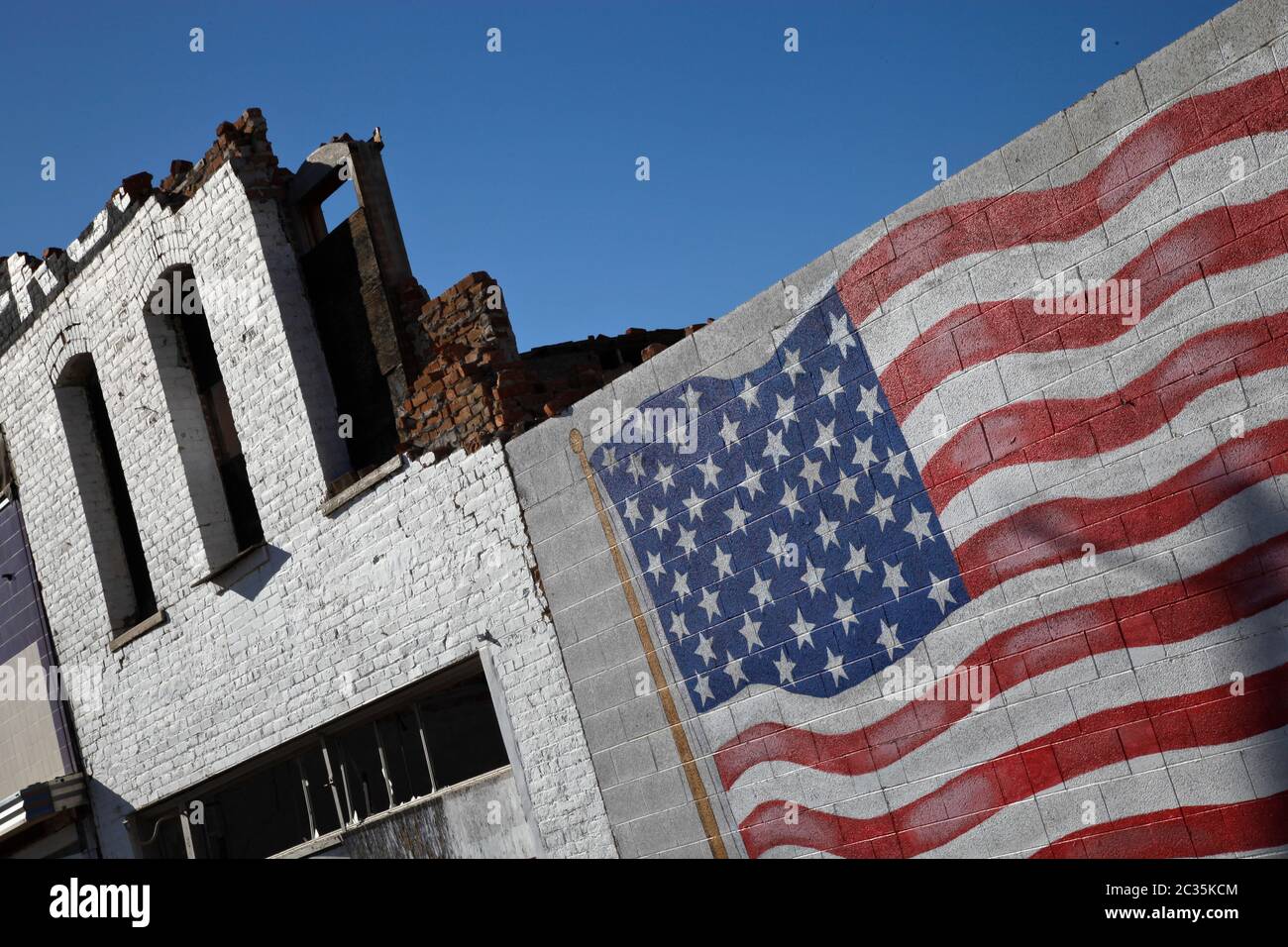 USA American flag on building being destroyed for a new commercial ...
