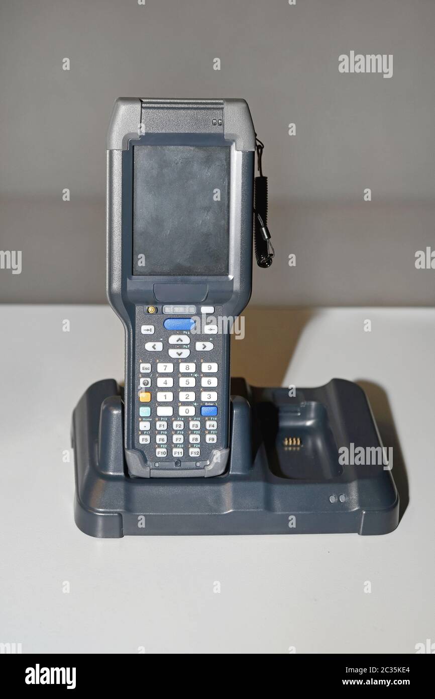 Handheld Laser Barcode Scanner Reader at Charger Dock Stock Photo - Alamy
