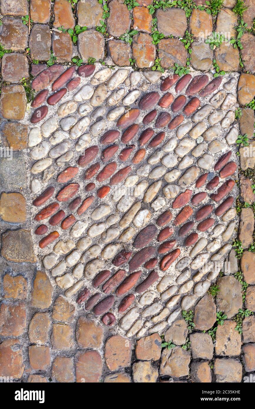 Shield Shaped Small Stones Mosaic in Pavement Stock Photo - Alamy