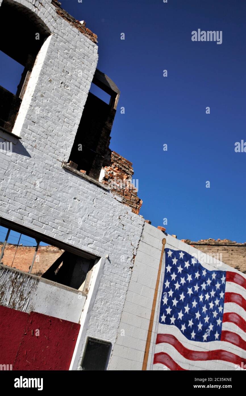 USA American flag on building being destroyed for a new commercial ...