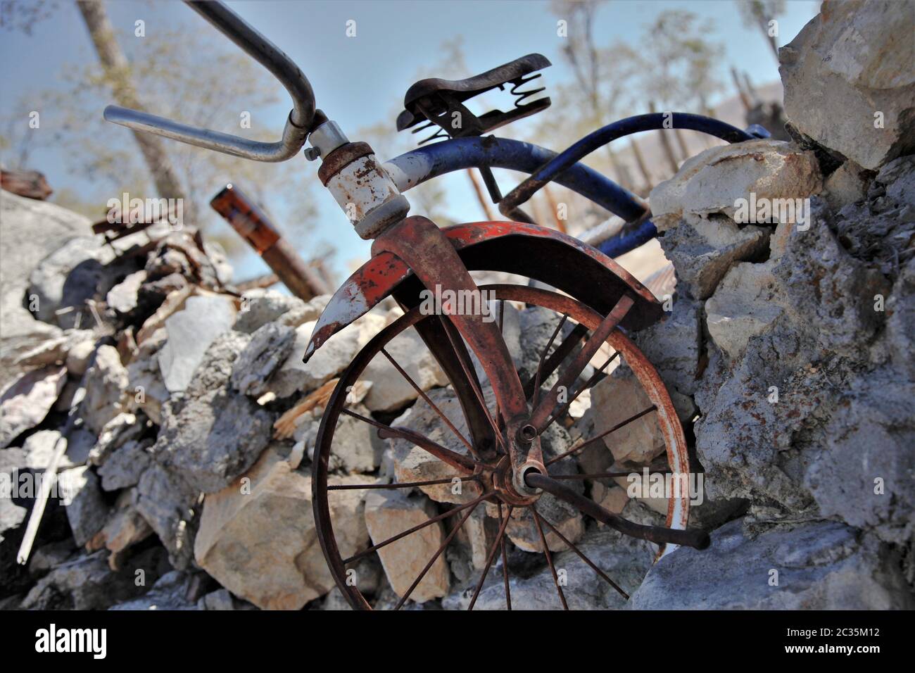 Old rusting bike bicycle on family farm which is abandoned by failing ...