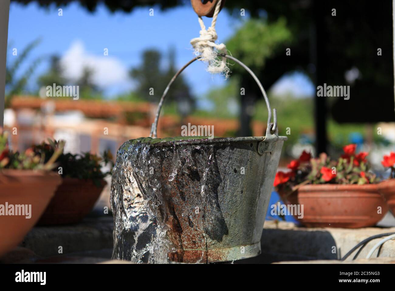 Lessons from the well bucket of refreshing water Stock Photo - Alamy
