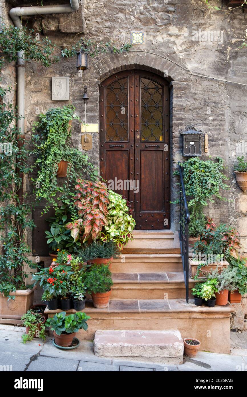 Flowers in pots on the stone steps medieval house in Assisi Stock Photo ...