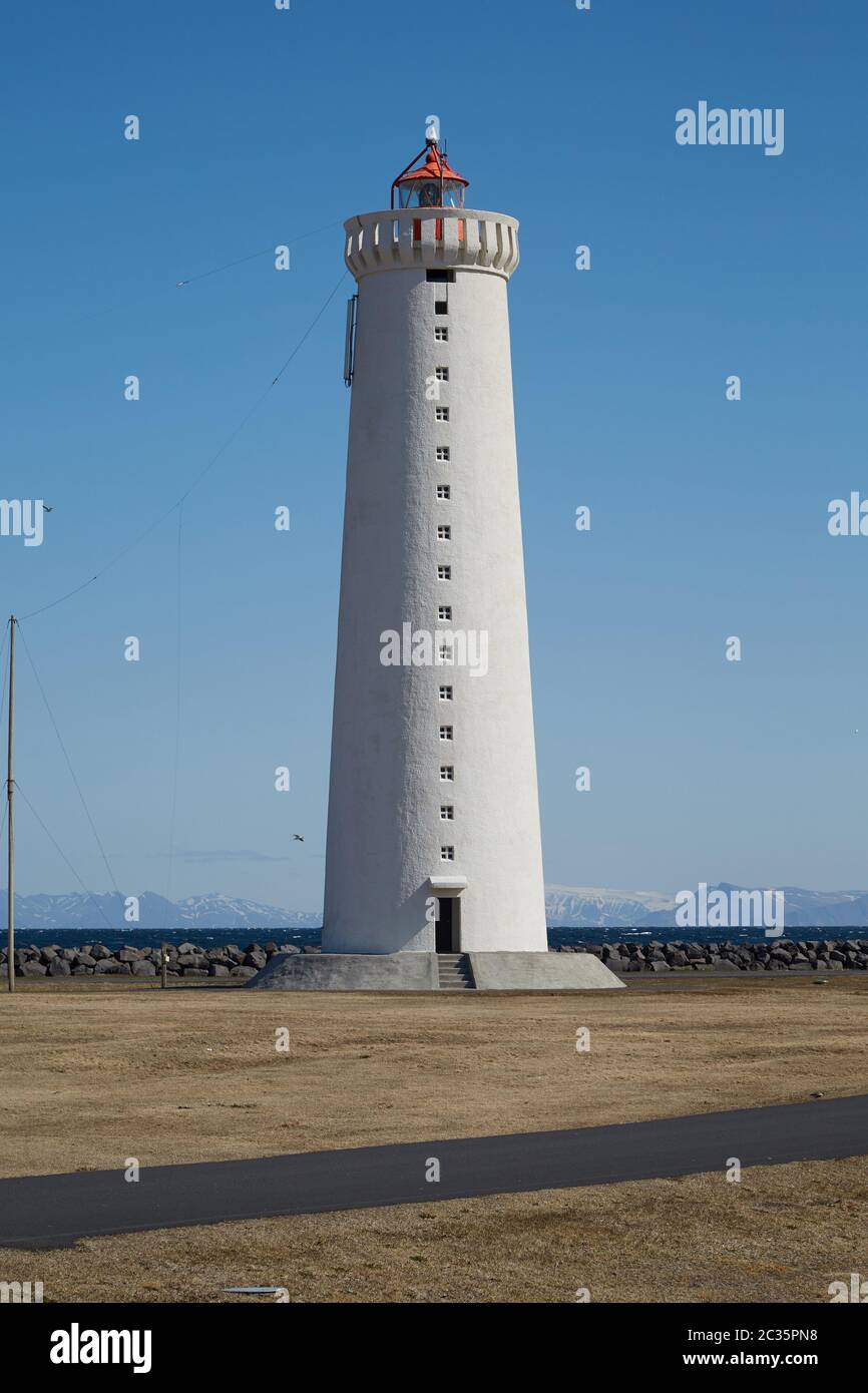 Small lighthouse on the tip of a peninsula Stock Photo - Alamy