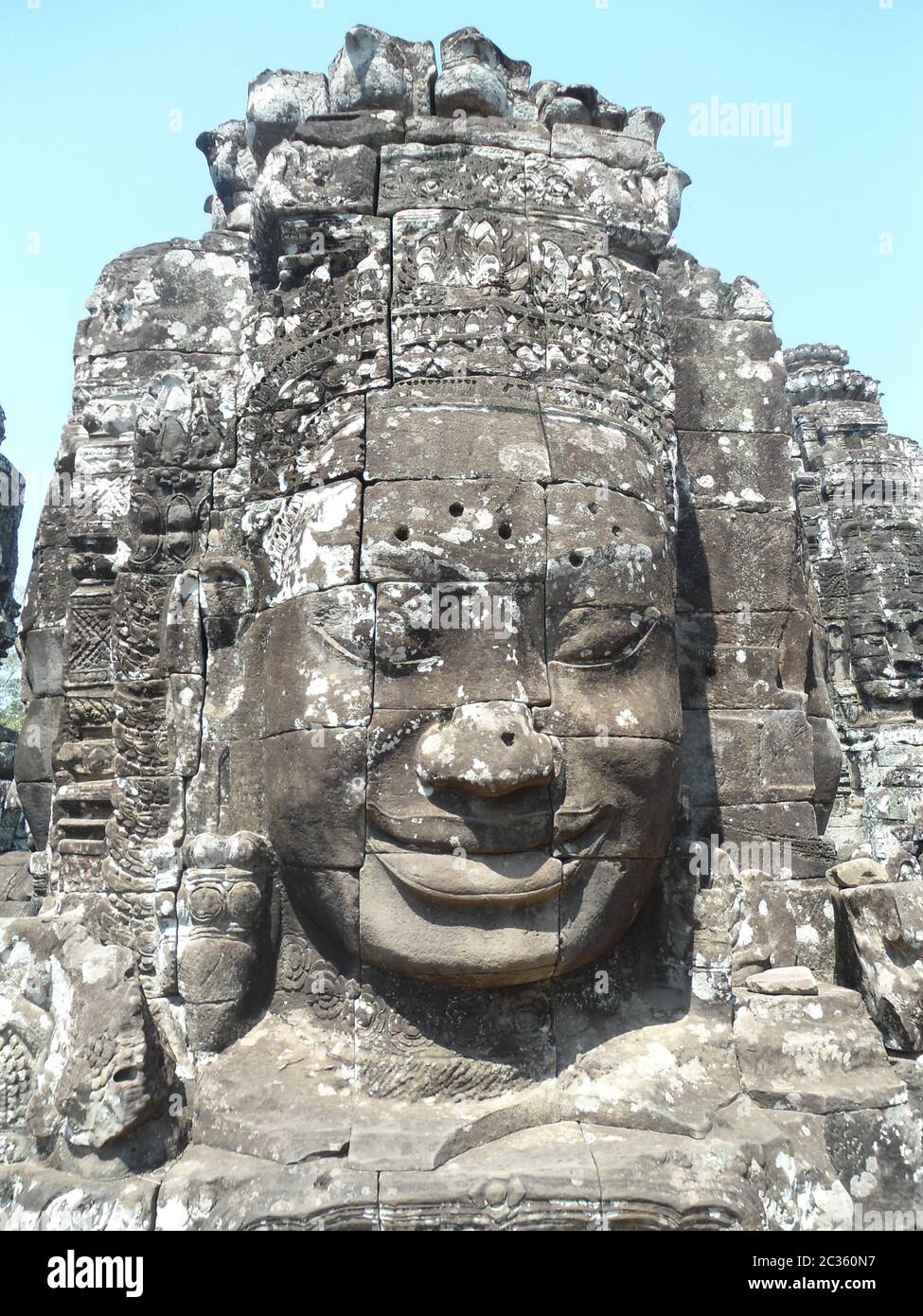 Faces masoned in Stone in Cambodia Angkor smiling ancient culture Stock ...