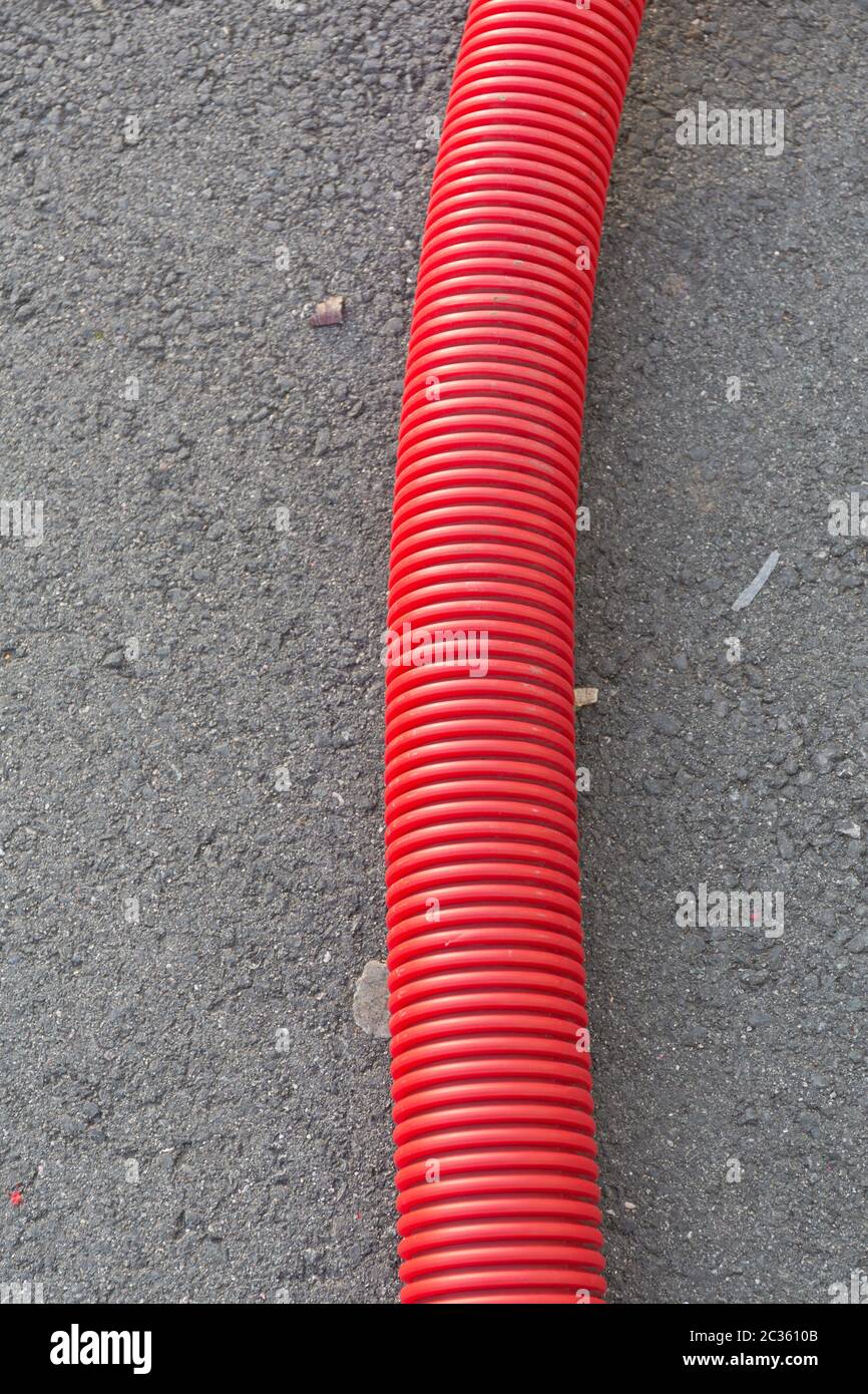 Red Plastic Tube at Street Construction Site Stock Photo - Alamy