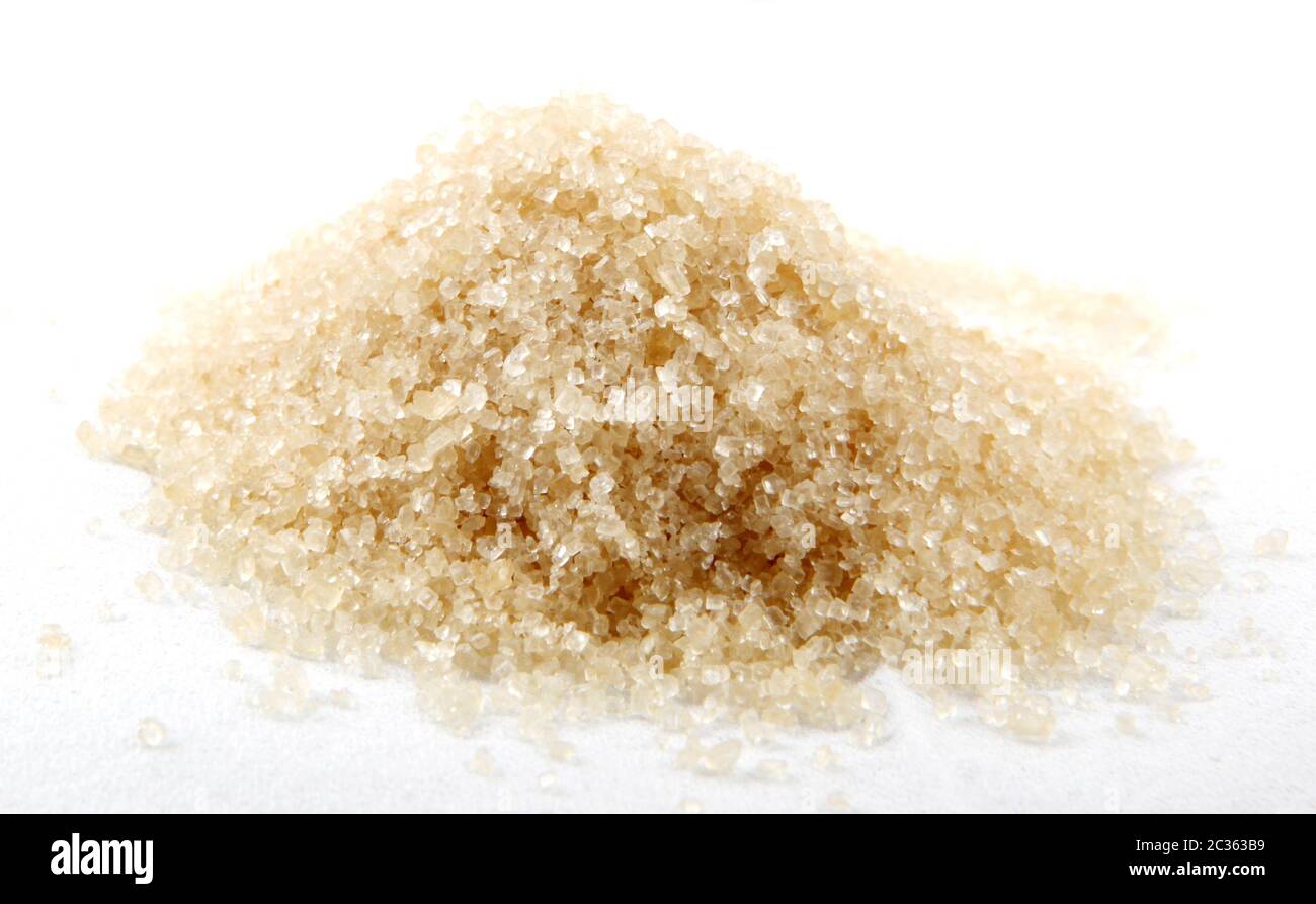 Brown sugar crystals of white background Stock Photo - Alamy