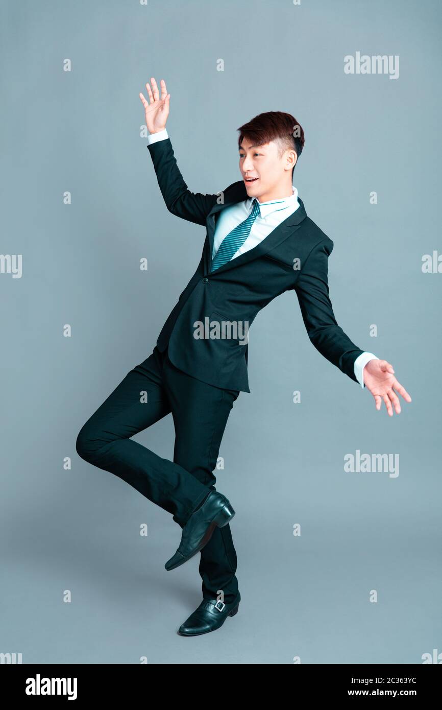 Happy young business man dancing in motion Stock Photo - Alamy