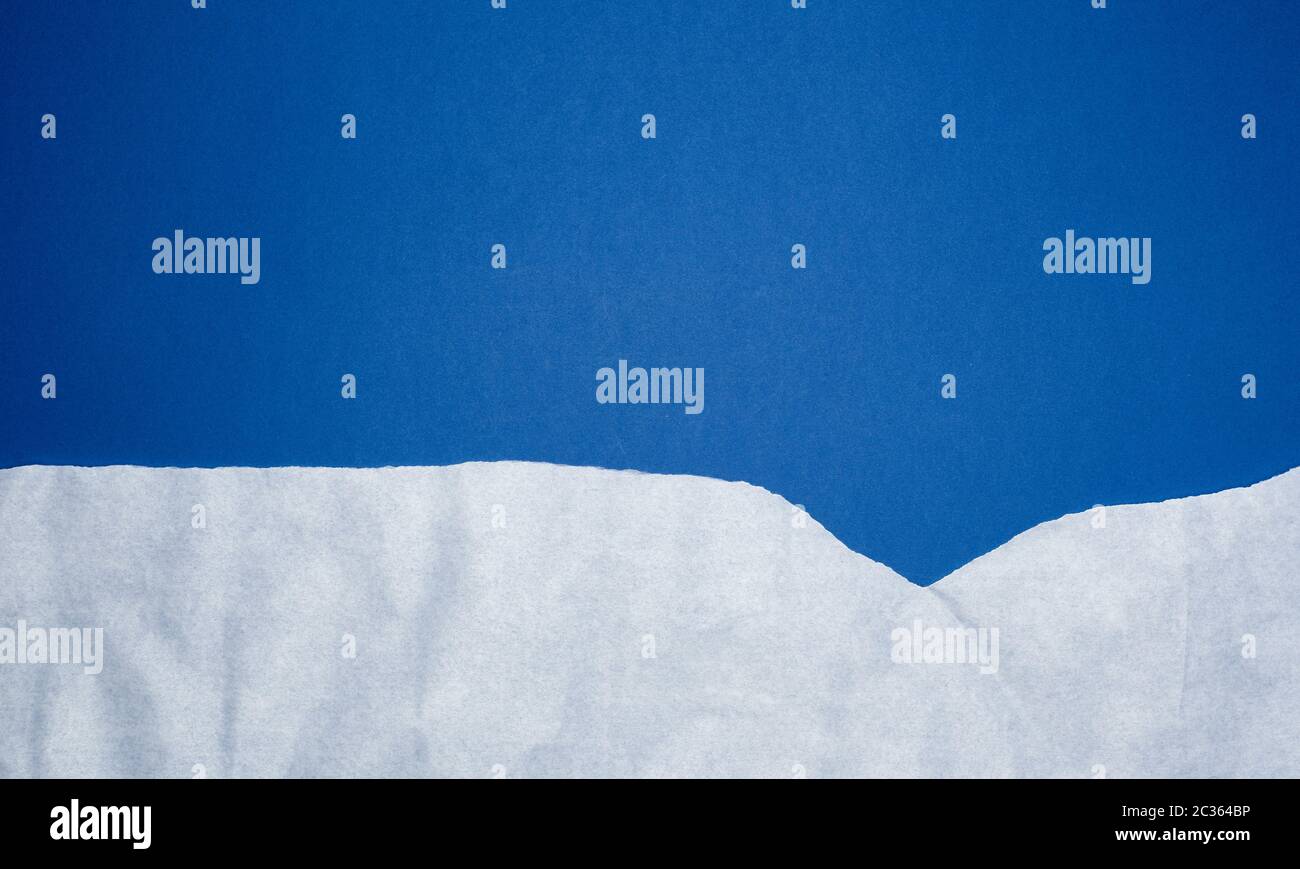 dark blue background with white crumpled torn paper elements, place for ...