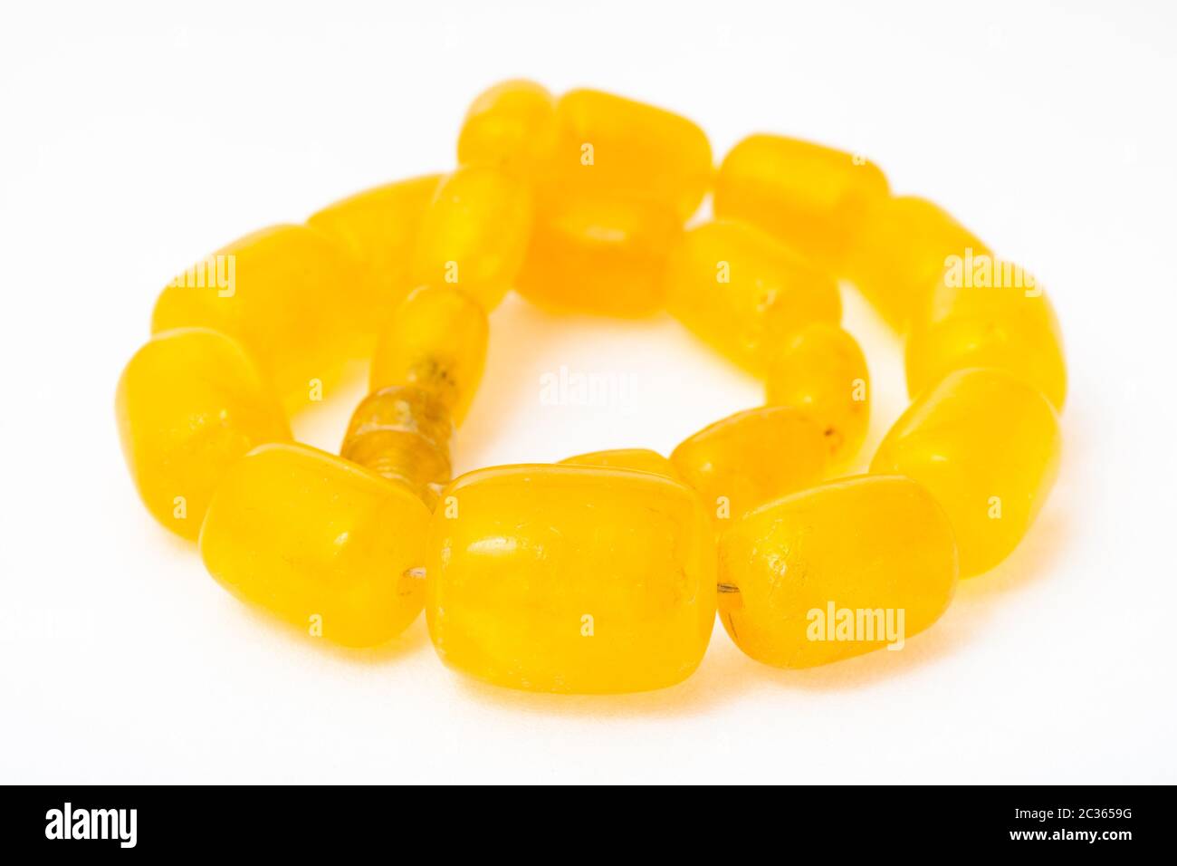 vintage coiled necklace from yellow melted amber on white paper ...