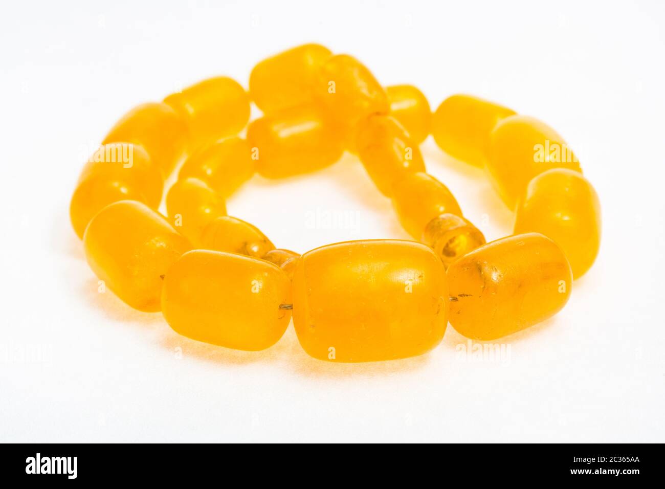 vintage spiral necklace from yellow melted amber on white paper ...