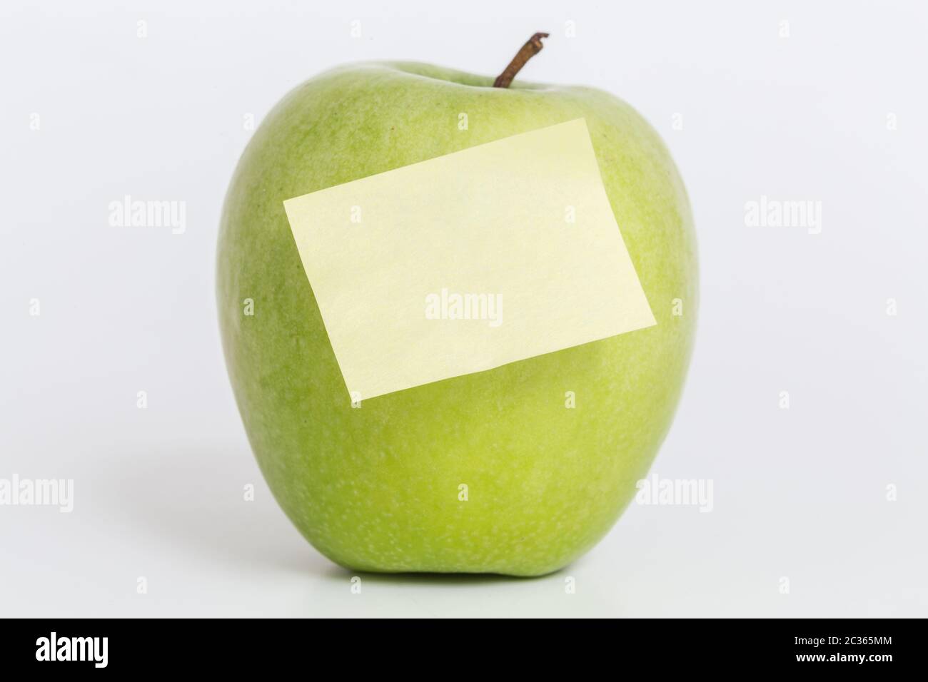 Apple with note and white background Stock Photo - Alamy
