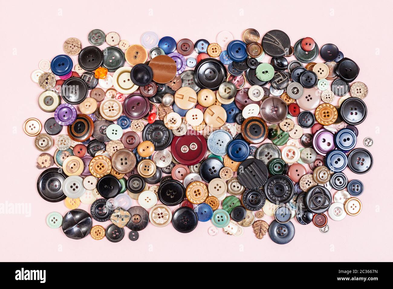 top view of pile of many various buttons on pink background Stock Photo ...