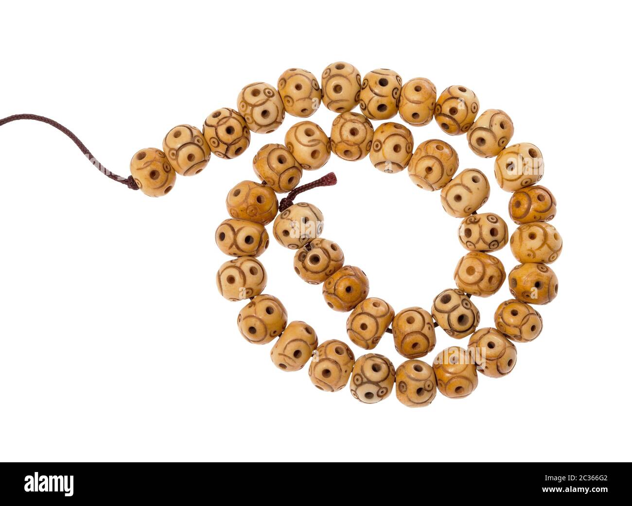 top view of spiral string of carved bone beads isolated on white ...