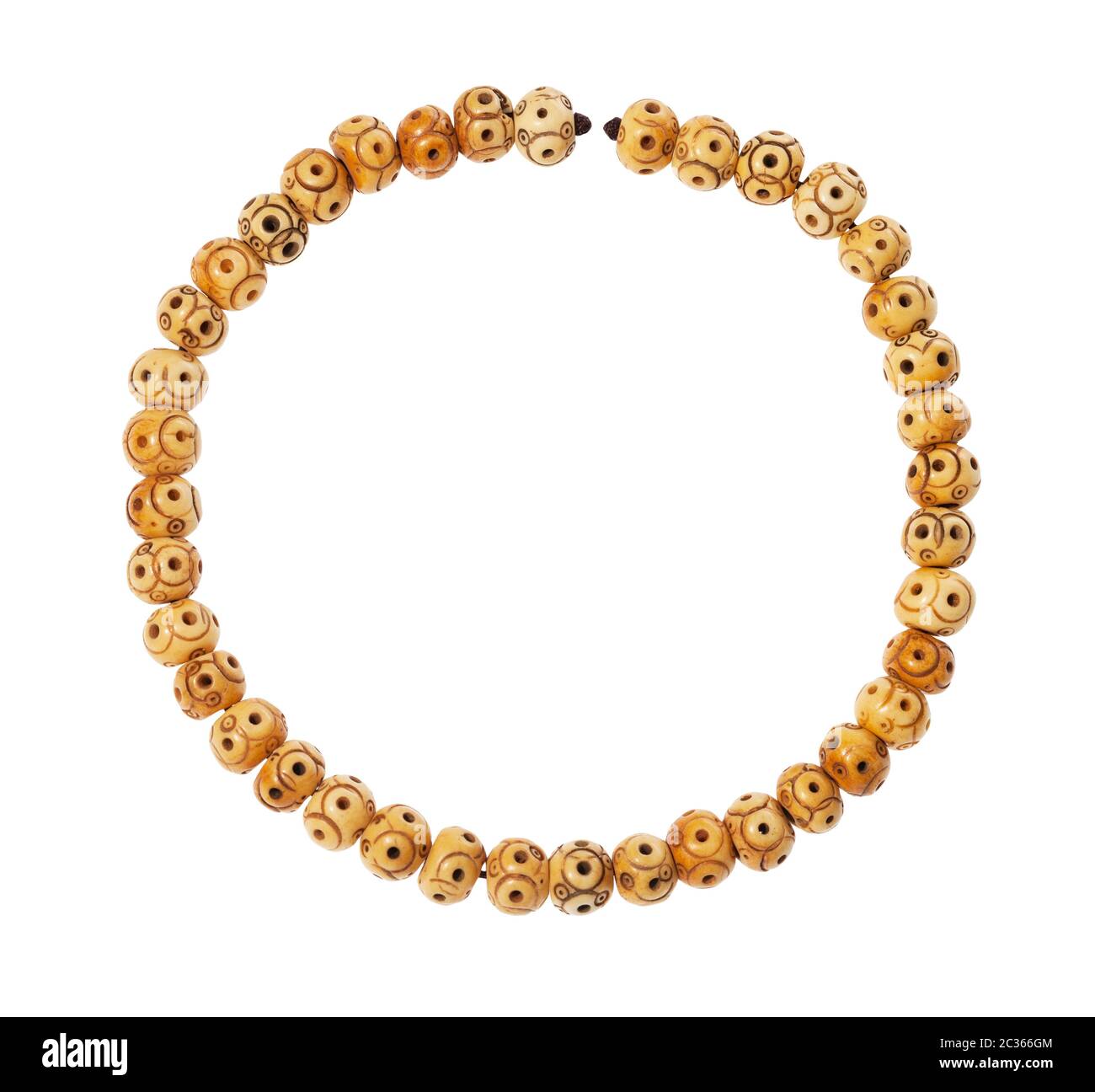 top view of string of carved bone beads isolated on white background ...