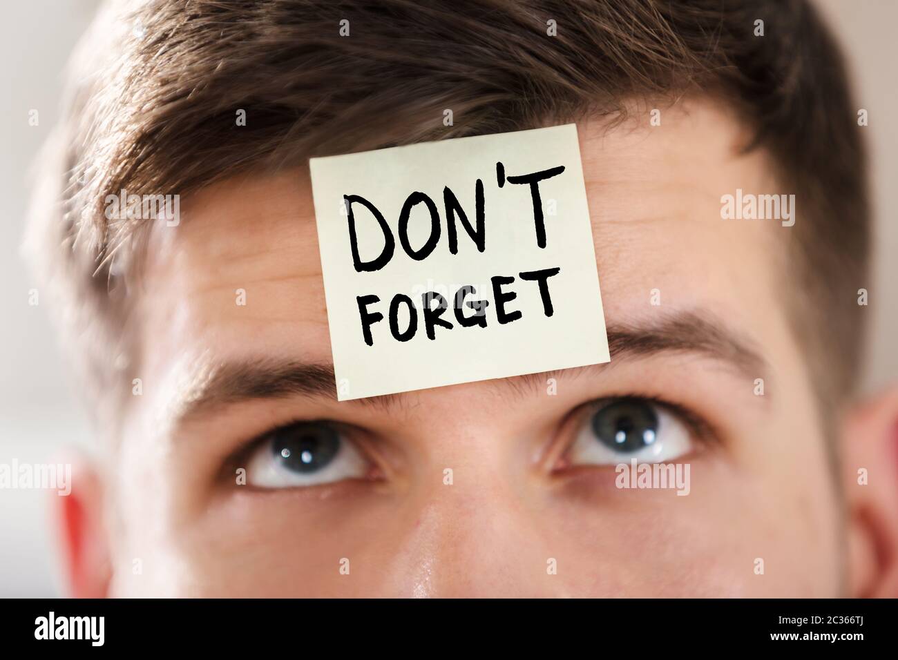 Sticky Note With Don't Forget Text Stuck On Forehead Of A Young ...