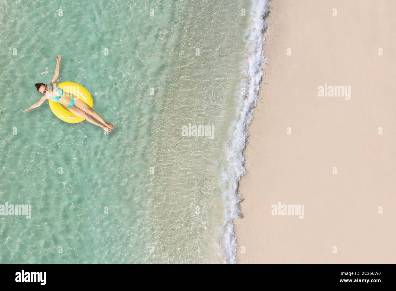 Overhead View Of A Young Woman Enjoying Floating In Inflatable Tube On ...