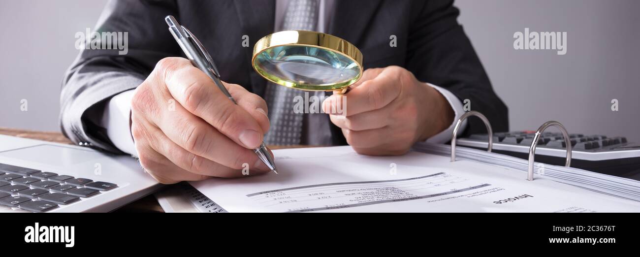 Close-up Of A Auditor's Hand Looking At Receipts Through Magnifying ...