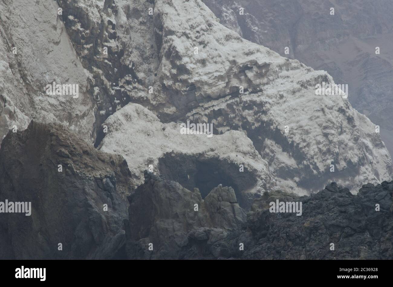 Sea cliffs covered with guano, seabird droppings. Las Cuevas. Arica y ...