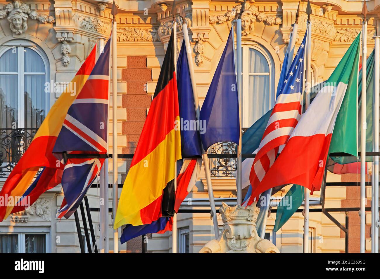 World International Flags at Poles in Front of Building Stock Photo - Alamy