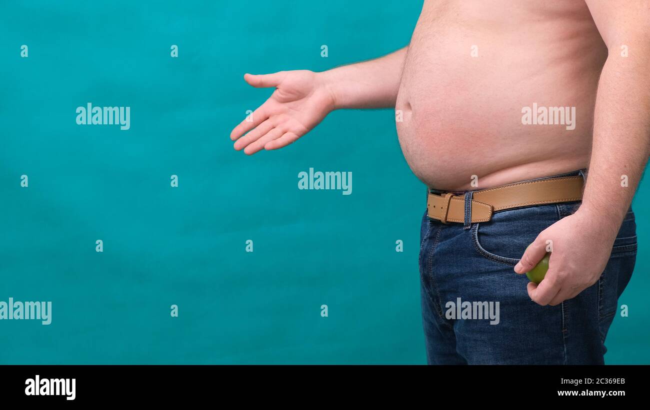 fat man with a big belly shows a sign with his hand. The concept of ...