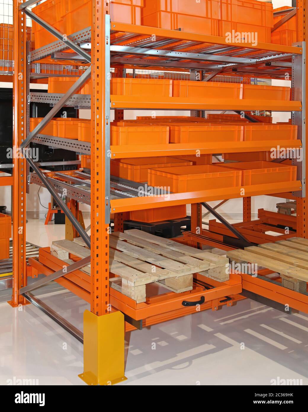 Orange Gravity Shelving System for Storage in Warehouse Stock Photo - Alamy