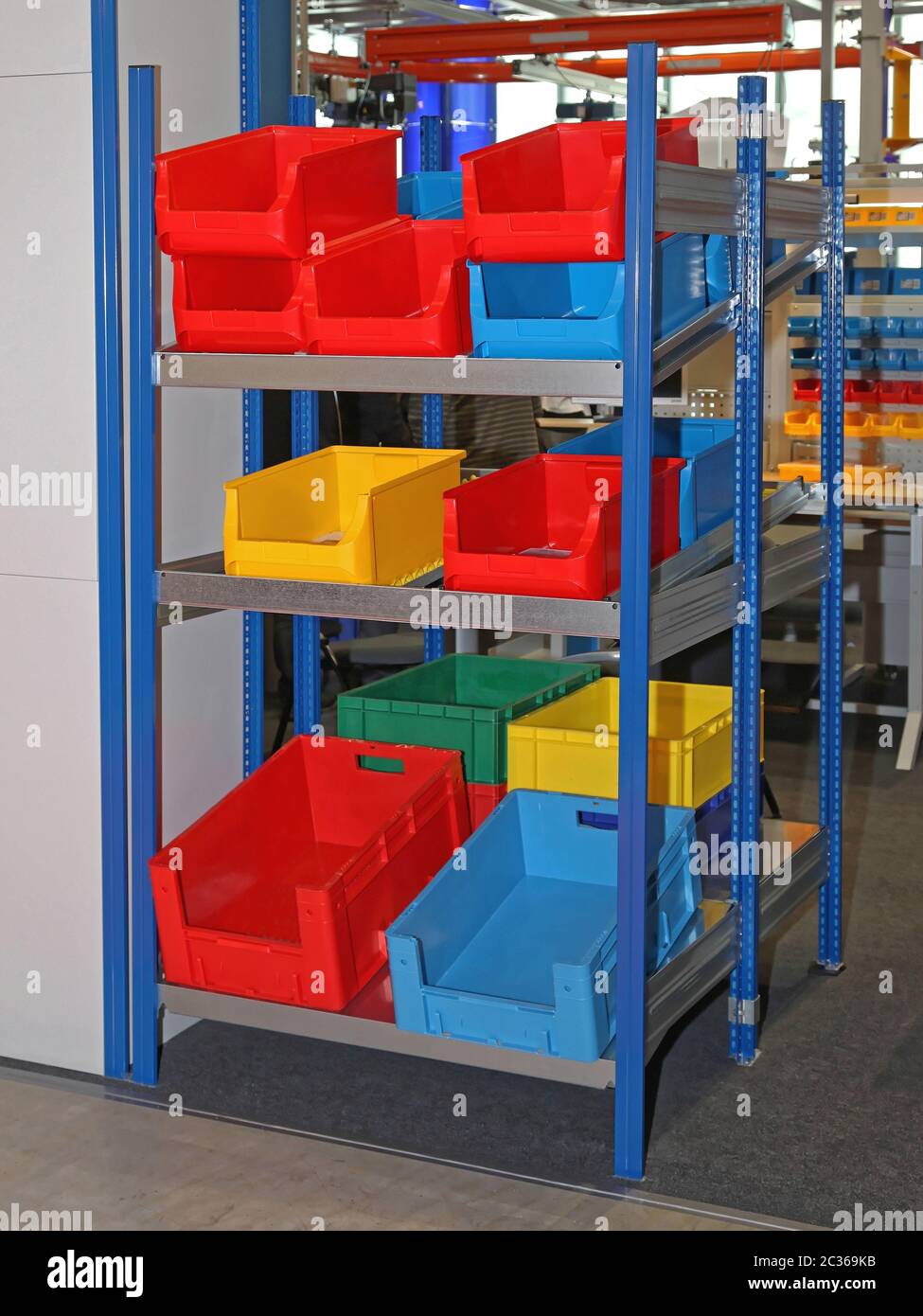 Colorful Plastic Bins and Crates in Gravity Shelf Storage Stock Photo ...